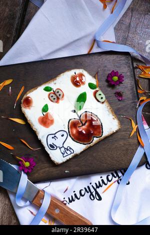 One toast topped with cheese and jam on a white plate Stock Photo - Alamy