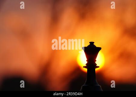 chess pieces on sunset background and golden hour Stock Photo - Alamy