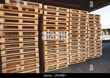 Wooden pallets heap in the cargo warehouse for transportation and ...