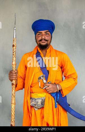 Portrait of a Sikh warrior in traditional dress with a weapon and a ...
