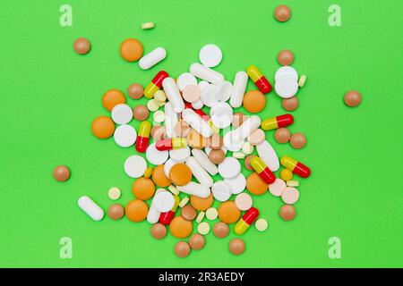 multicolored pills and capsules on a pink background Stock Photo - Alamy