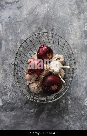 Several garlic onions in a basket isolated over white Stock Photo - Alamy