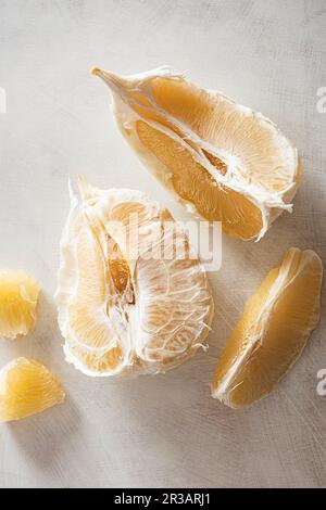 Top view of fresh peeled pomelo on bright wooden table background for ...