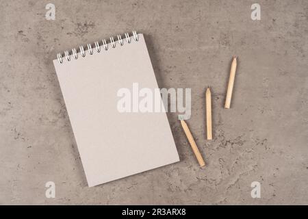 Modern workplace with recycled paper spiral blank notebook and wood ...