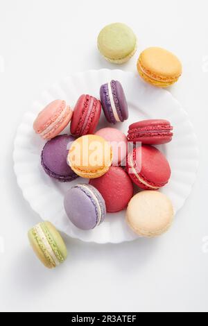 Colourful macaroons on the plates Stock Photo - Alamy