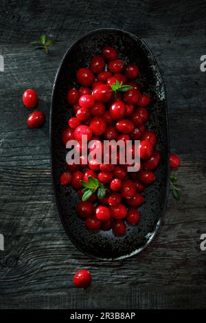 Top view red cranberries inside a transparent jar, with black ...