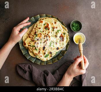 Top view with single naan bread on a blue table. Delicious homemade ...