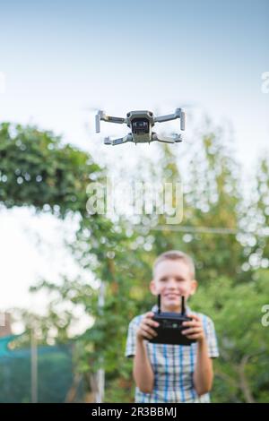 Kid flying drone. Boy operate drones. Child Operating Quadcopter ...