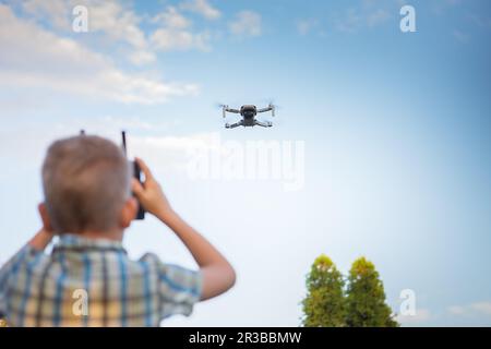 Kid flying drone. Boy operate drones. Child Operating Quadcopter ...