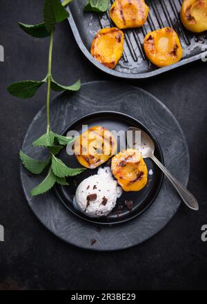 Vegan tonka bean ice cream with grilled peaches Stock Photo - Alamy