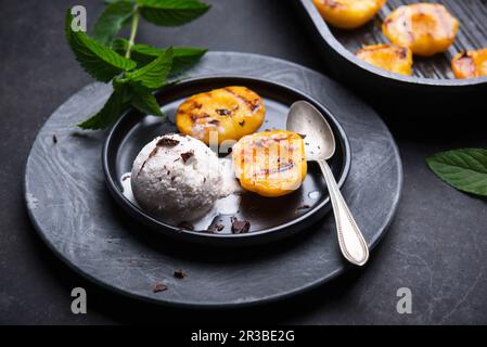 Vegan tonka bean ice cream with grilled peaches Stock Photo - Alamy