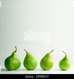 Four pears in a row Stock Photo - Alamy