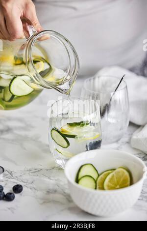 Pouring fresh cold infused water into a glass Stock Photo - Alamy