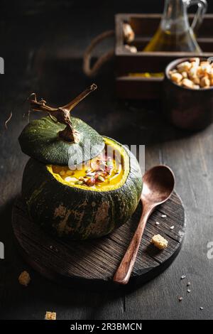 Pumpkin soup served in the hollowed out hokkaido pumpkin Stock Photo ...