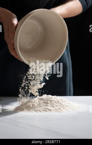 Corn or grain being made into flour using hand operated mill stones at ...