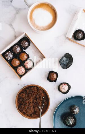 assorted chocolates confectionery with cup of coffee in sunny landscape ...