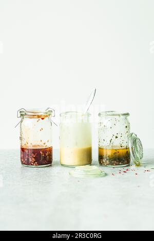 Sweet chili sauce and various dressings on a buffet table in a garden ...