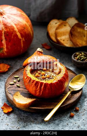 Pumpkin soup served in the hollowed out hokkaido pumpkin Stock Photo ...