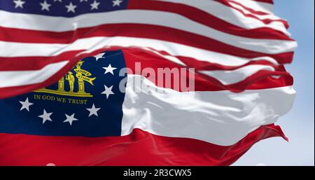 Flags of Georgia and United States waving in the wind on a clear day ...