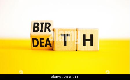 Birth or death symbol. Businessman turns wooden cubes and changes the ...