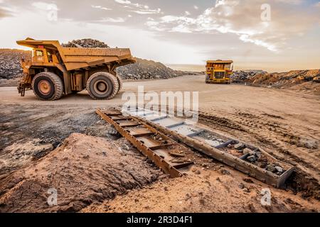 Mining dump trucks transporting Platinum ore for processing Stock Photo ...
