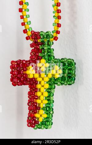 Christian Cross made with red color powder, isolated on a white ...