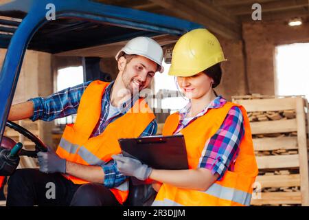 Young professional factory workers discussing working issues Stock ...