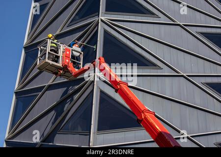 Window cleaning crew on articulating boom lift at Rotermanni Quarter in ...