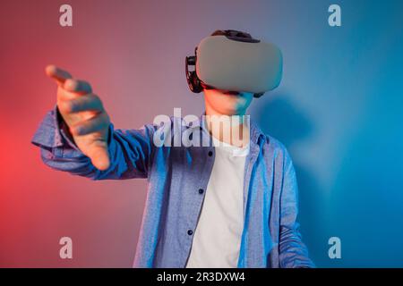 Teenager boy using a gaming gadget for virtual reality. Augmented ...