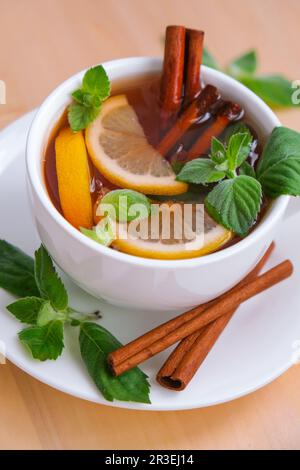 Black and green tea with lemon, cinnamon sticks and mint leaves on ...