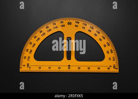 Yellow school protractor on blackboard, closeup view Stock Photo - Alamy