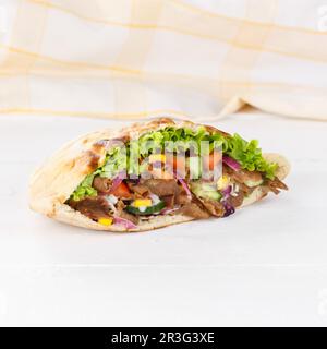 Doner kebab Doner kebab half fast food food in pita bread with fries on ...