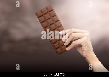 Human hand holding chocolate bar isolated over white background Stock ...