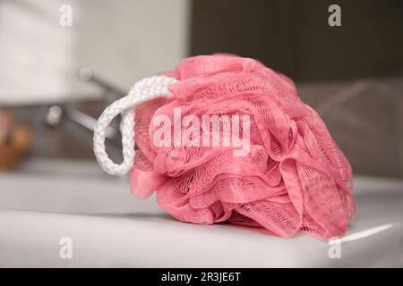 Pink shower puff on washbasin in bathroom Stock Photo - Alamy