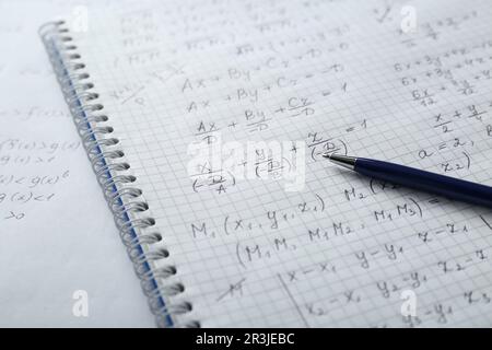 Notebook with different mathematical formulas and pen, top view Stock ...