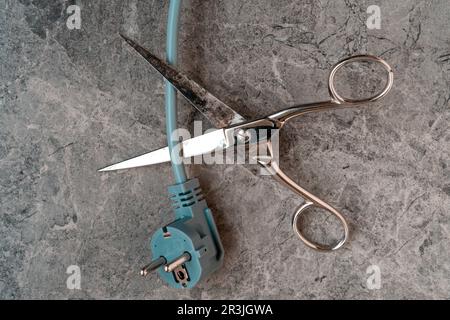 Scissors cutting electric wire Stock Photo - Alamy