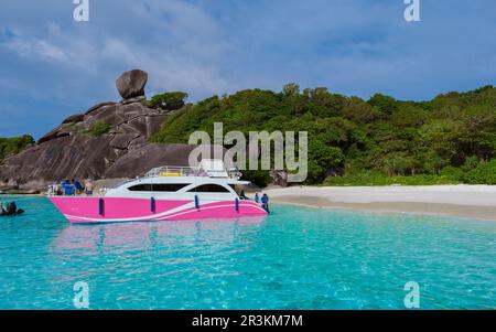 Tourist boat and Turqouse colored ocean and white beach at the tropical ...