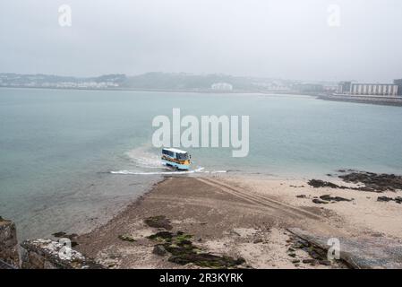 The amphibious duck ferry vehicle negotiates the tidal waters towards ...