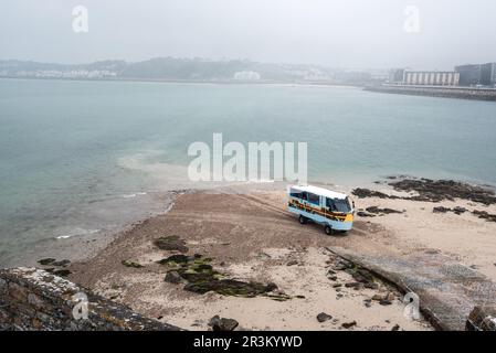 The amphibious duck ferry vehicle negotiates the tidal waters towards ...