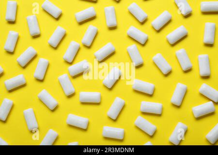 White chewing gums on the yellow and green background, high angle view ...