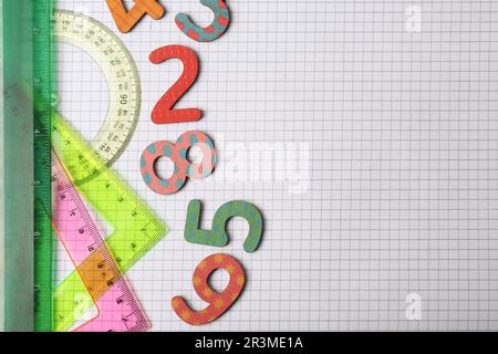 Colorful numbers on sheet of grid paper, flat lay. Space for text Stock ...