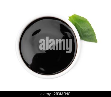 Balsamic glaze and basil leaf on white background, top view Stock Photo ...