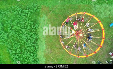 Carnival Merry Go Round aerial top view. Drone tracking rotation shoot ...