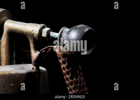 old and vintage blow torch isolated on black background with rust and ...