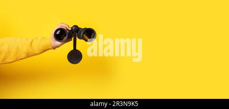 Binoculars in hand panoramic Stock Photo - Alamy