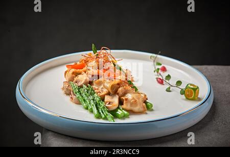 stir-fried sea snails slices, Japanese food Stock Photo - Alamy
