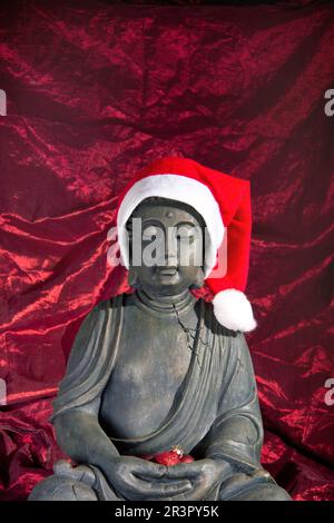 buddha statue with Santa Claus cap and Christmas decorations Stock ...