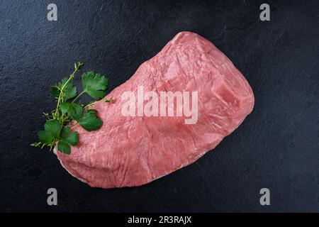 Raw rump cap steak or top sirloin steak in rustic plate with thyme and ...