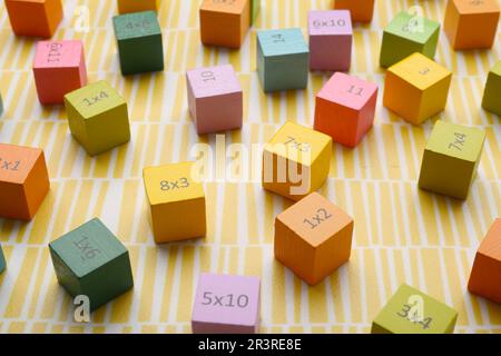 Colorful cubes with numbers and multiplications on yellow background ...