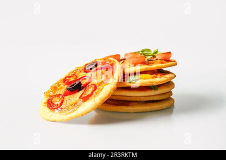 Different tasty mini pizzas on white background Stock Photo - Alamy